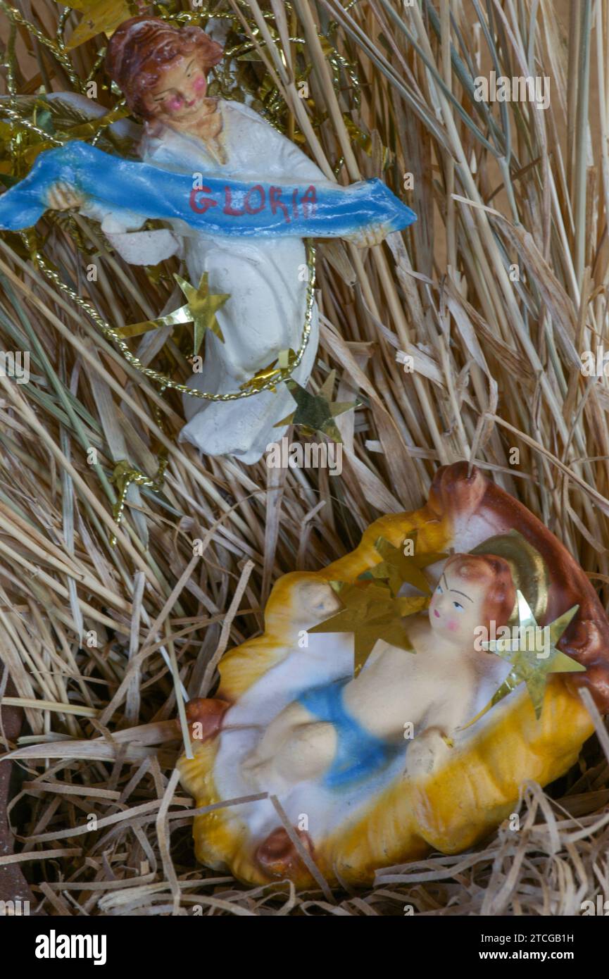 Christmas announces Jesus birth. Angel figure holds a banner Gloria ...