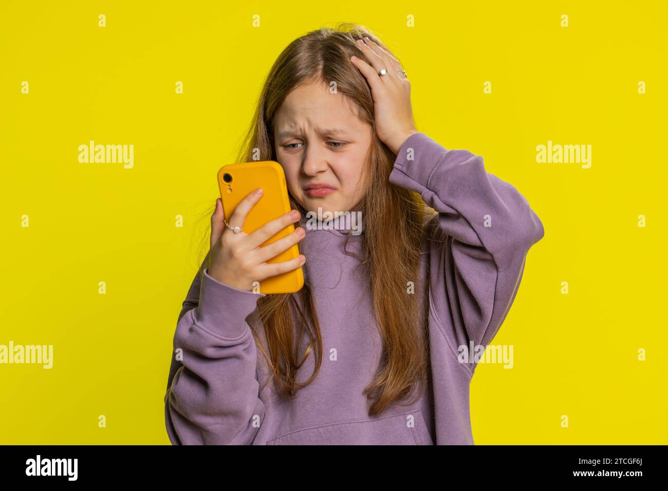 Portrait of upset sad preteen child girl kid use smartphone typing ...