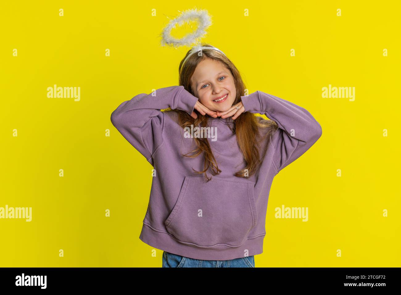 Portrait of smiling shy angelic young preteen child girl kid with angel ...