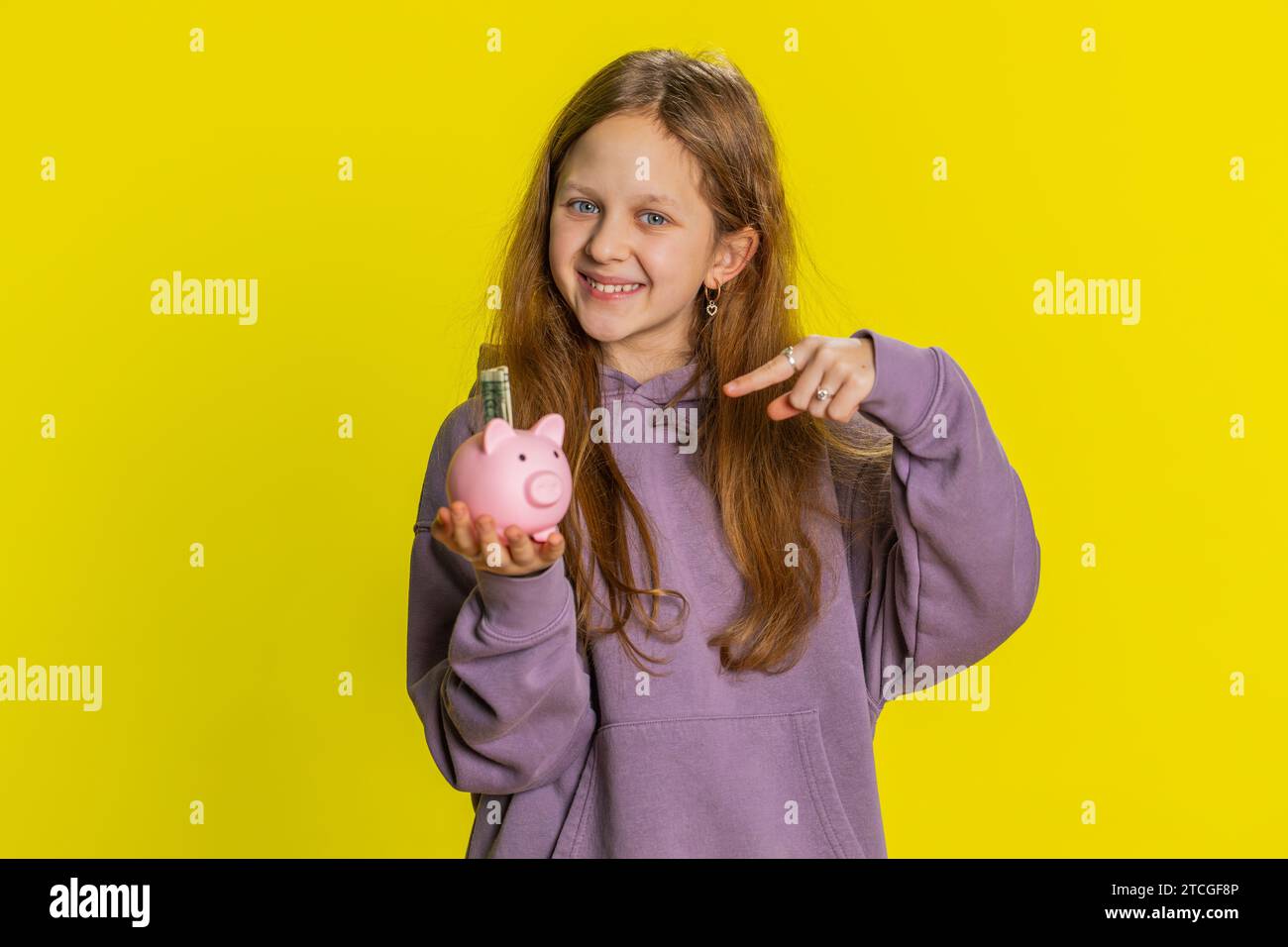 Young preteen child girl kid putting dollar pocket money cash into ...