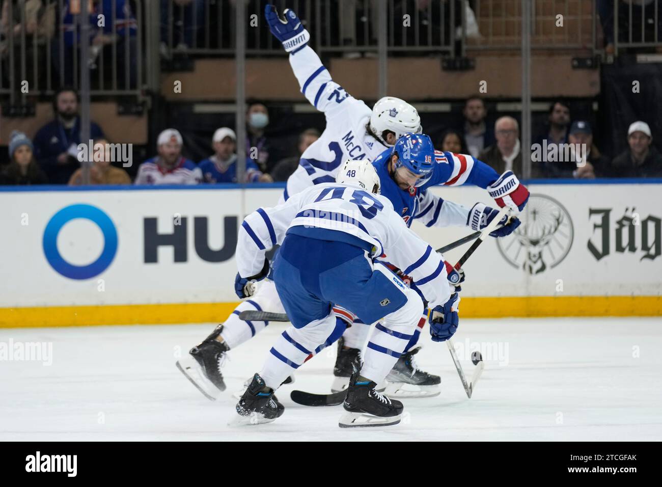 New York Rangers' Vincent Trocheck, right, tries to keep the puck from ...