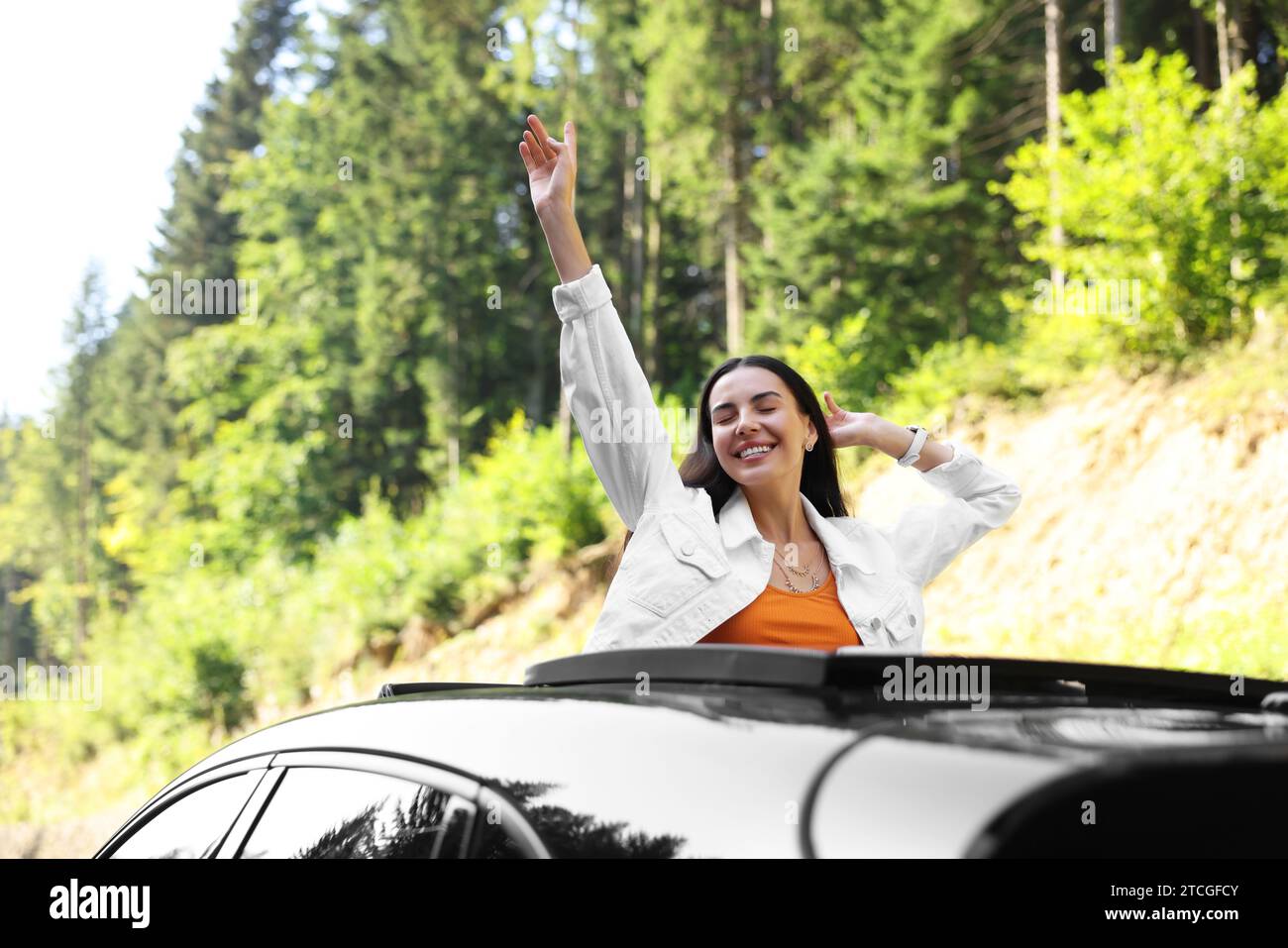 Happy woman car roof hi-res stock photography and images - Alamy