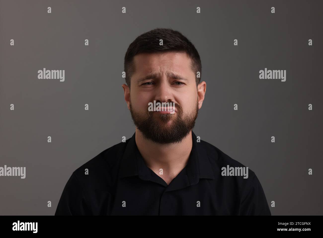 Personality concept. Emotional man on grey background Stock Photo - Alamy