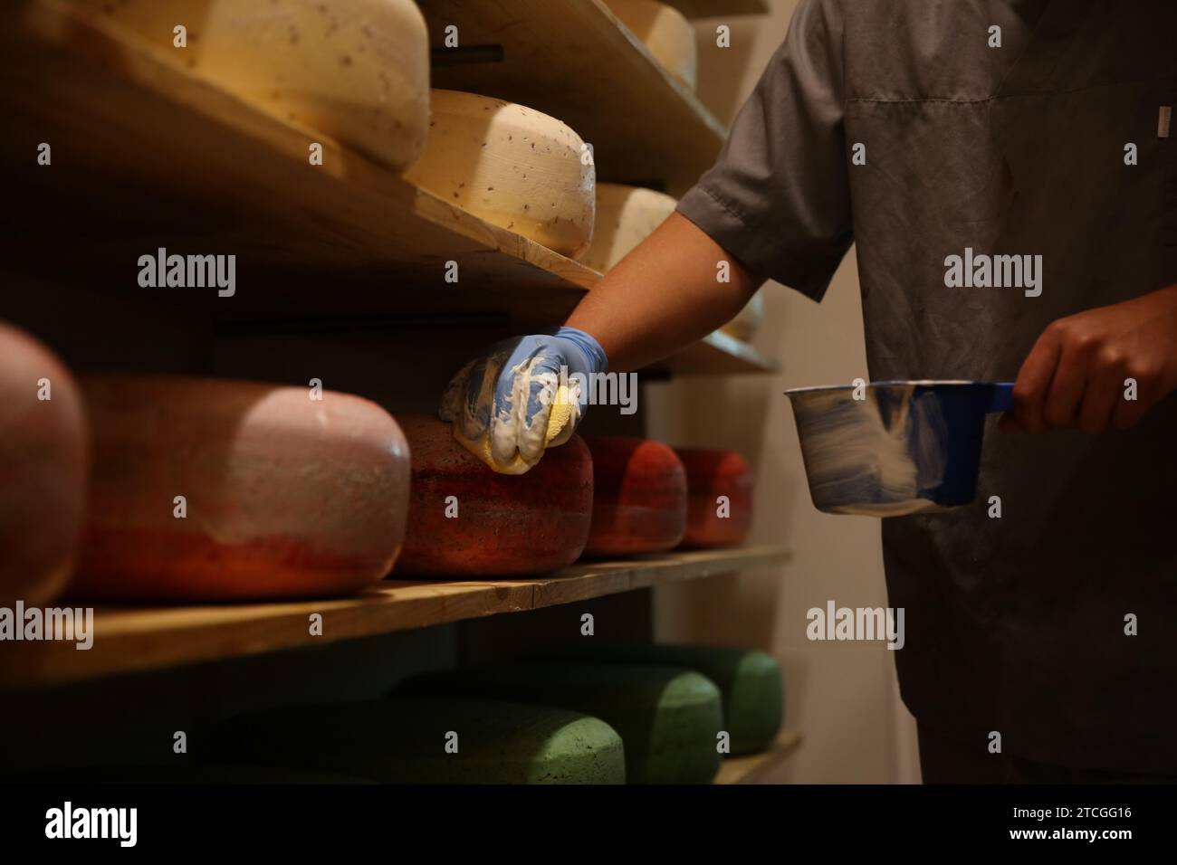 Worker coating cheese with wax in factory warehouse, closeup Stock ...