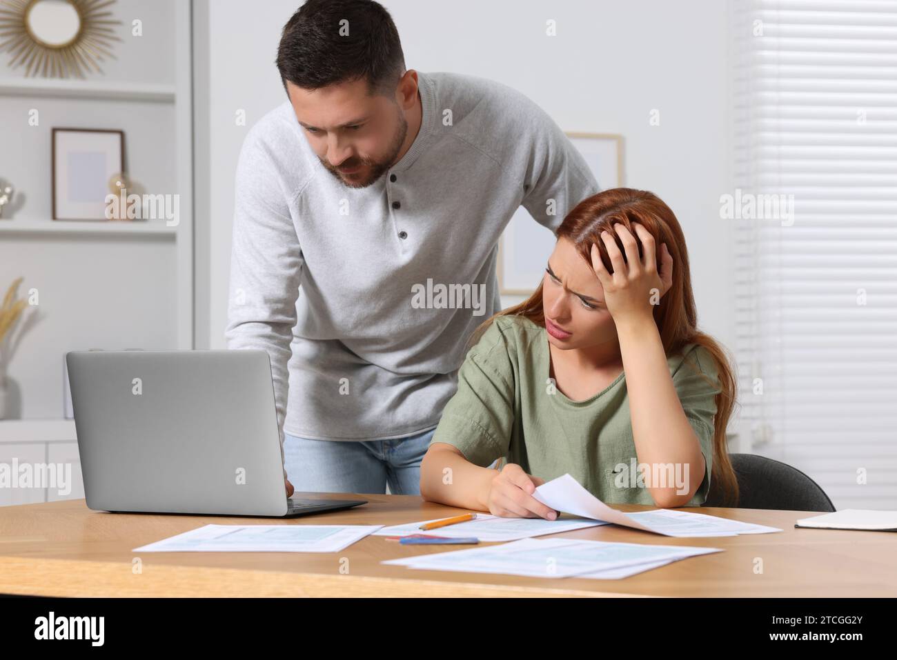 Couple doing taxes at table in room Stock Photo - Alamy