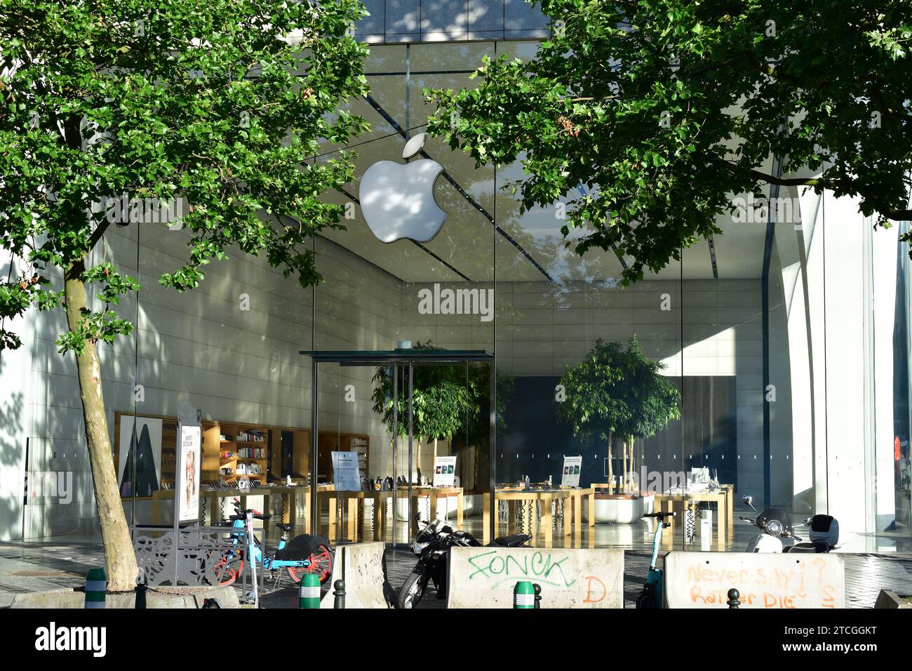 Glass facade of the Apple Store with a large Apple logo and typical ...