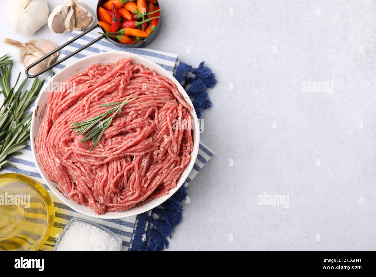 Flat lay composition with fresh raw ground meat on light table. Space ...