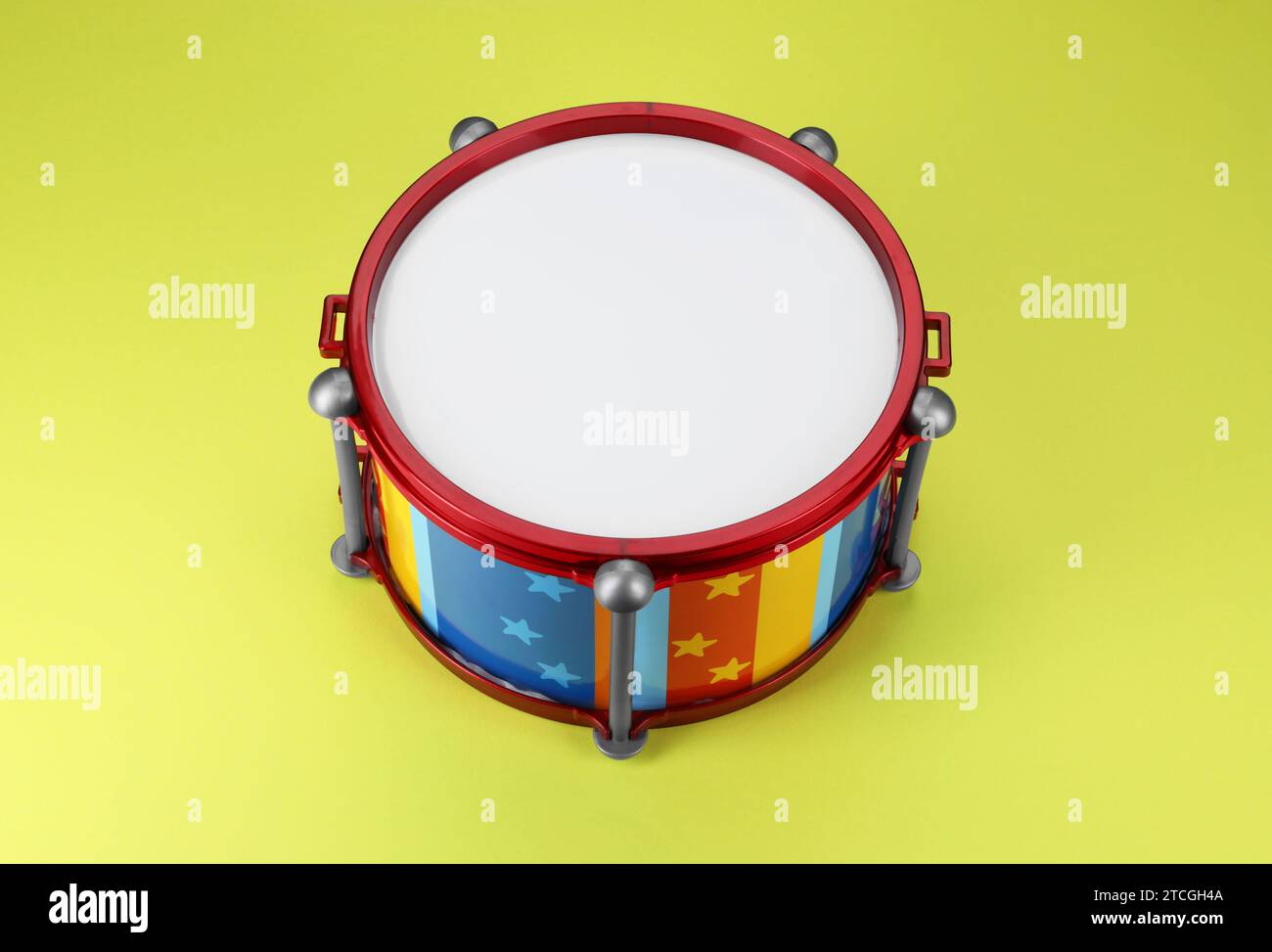 Colorful drum on light green background. Percussion musical instrument ...