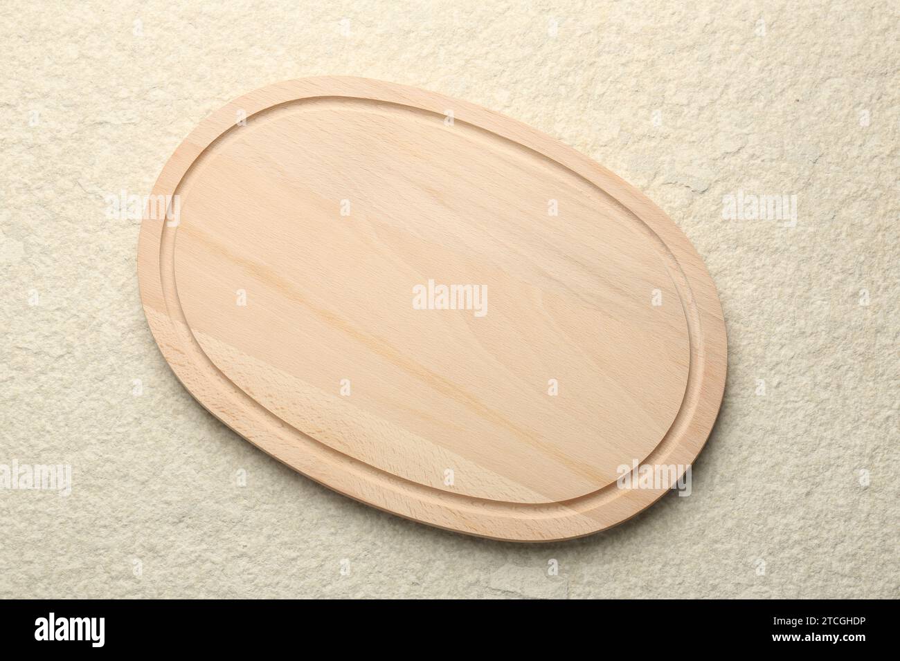 Wooden cutting board on beige table, top view. Space for text Stock ...