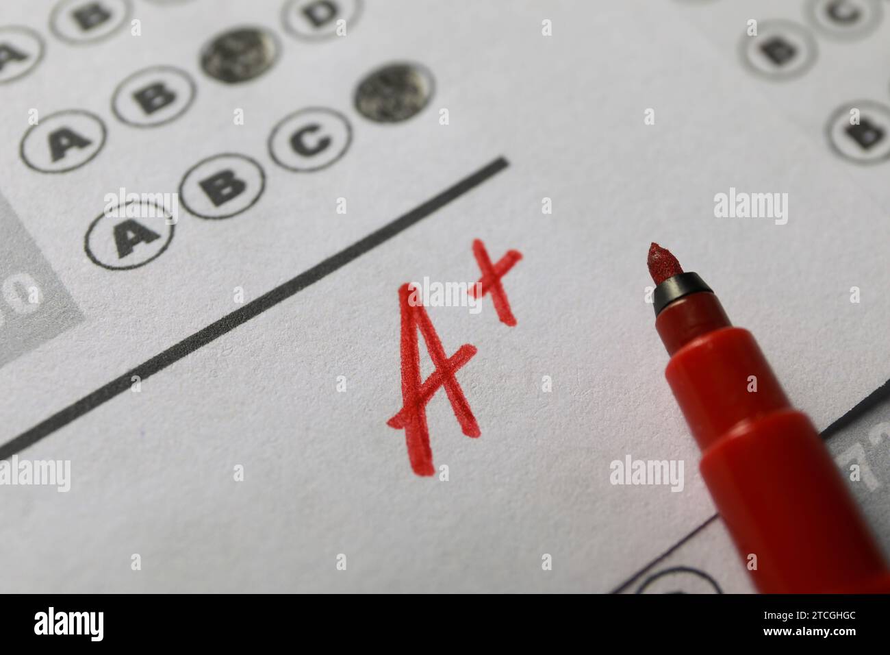 School grade. Letter A with plus symbol on answer sheet and red marker ...