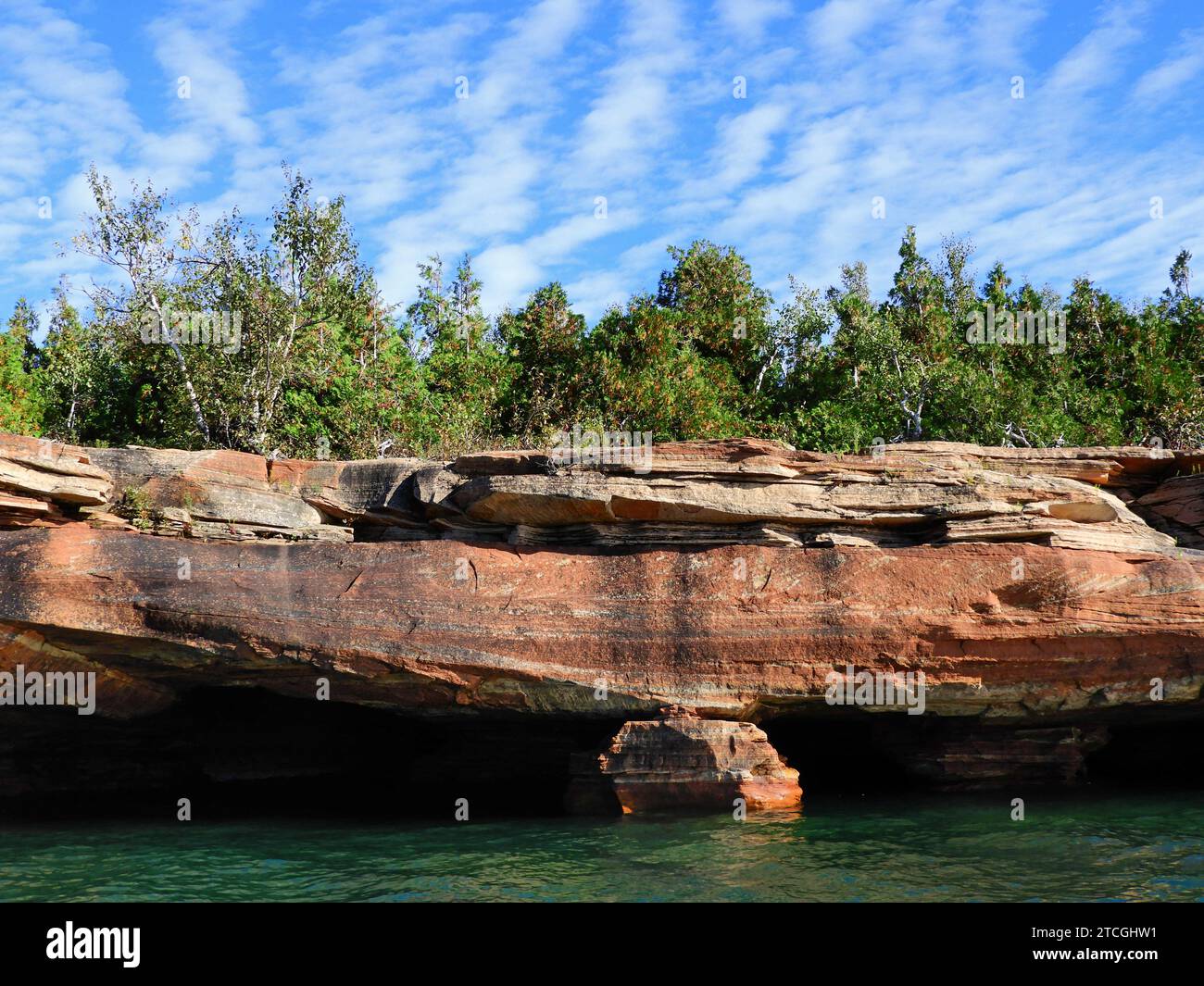 colorful, eroded sea caves of devil's island on sunny fall day in ...
