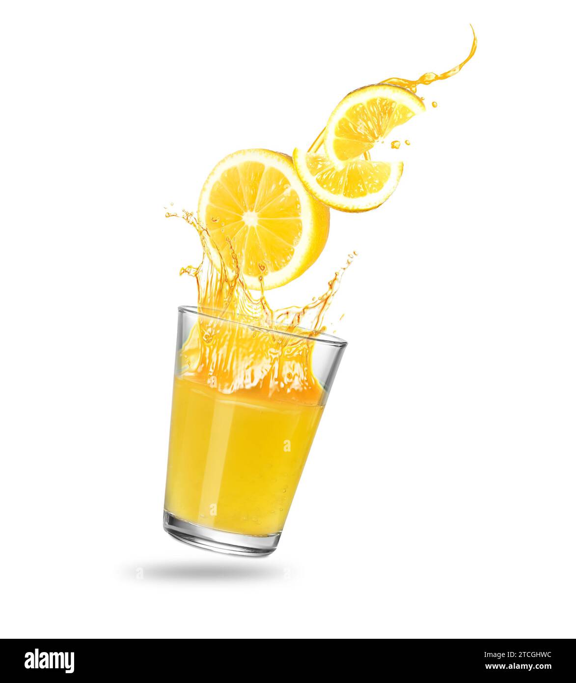 Juice splashing from glass on white background. Cut lemon falling into ...