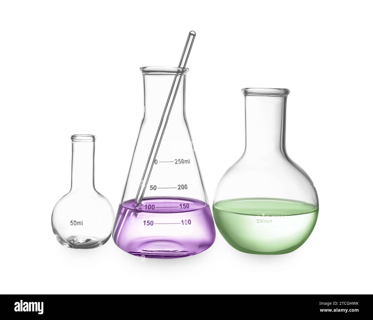 Glass flasks with colorful liquids and stirring rod isolated on white ...