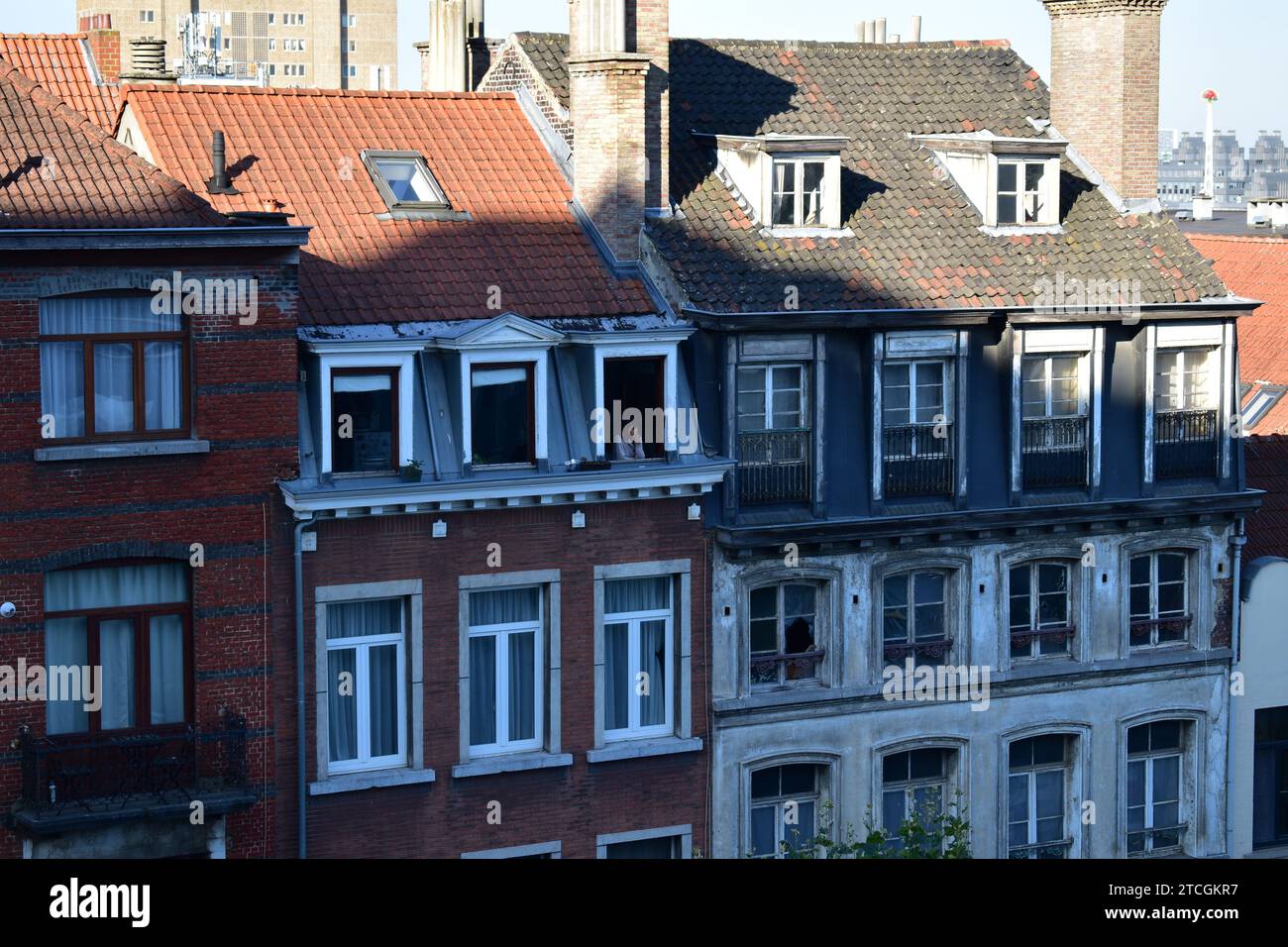 Woman smoking a cigarette through a open window in the top level ...