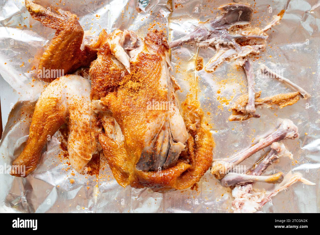 top view half eaten fresh roasted chicken at horizontal composition ...