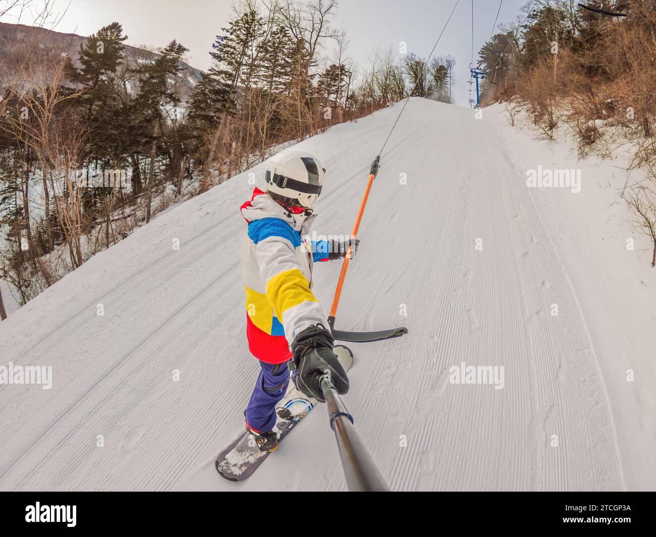 A daring man conquers snowy slopes with style, showcasing skill and ...