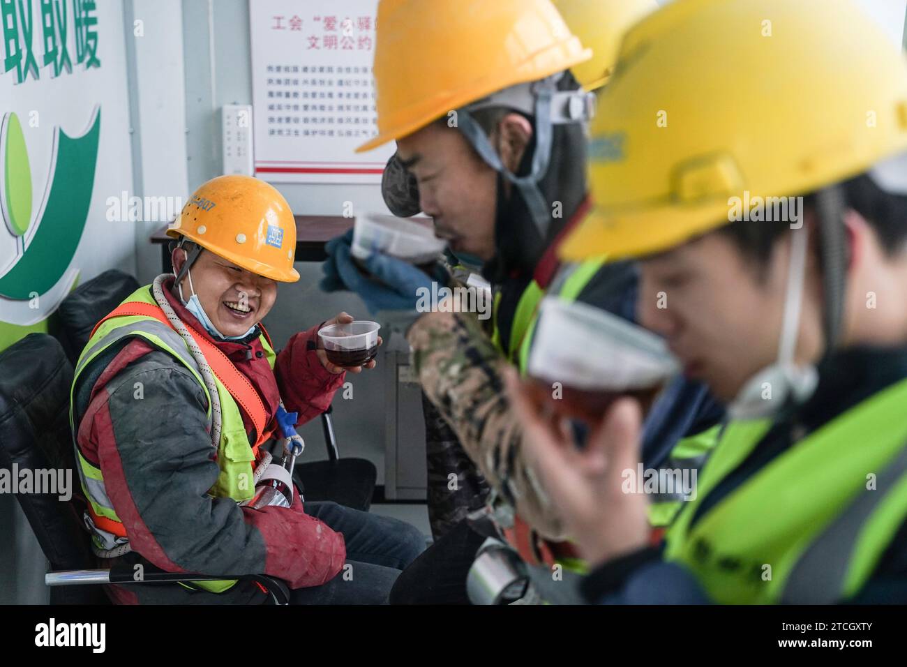 Beijing, China. 12th Dec, 2023. Workers drink ginger tea to keep warm ...