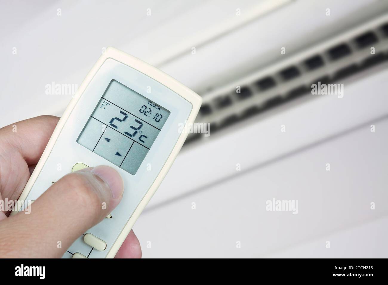 Hand hold remote control with conditioner background Stock Photo - Alamy