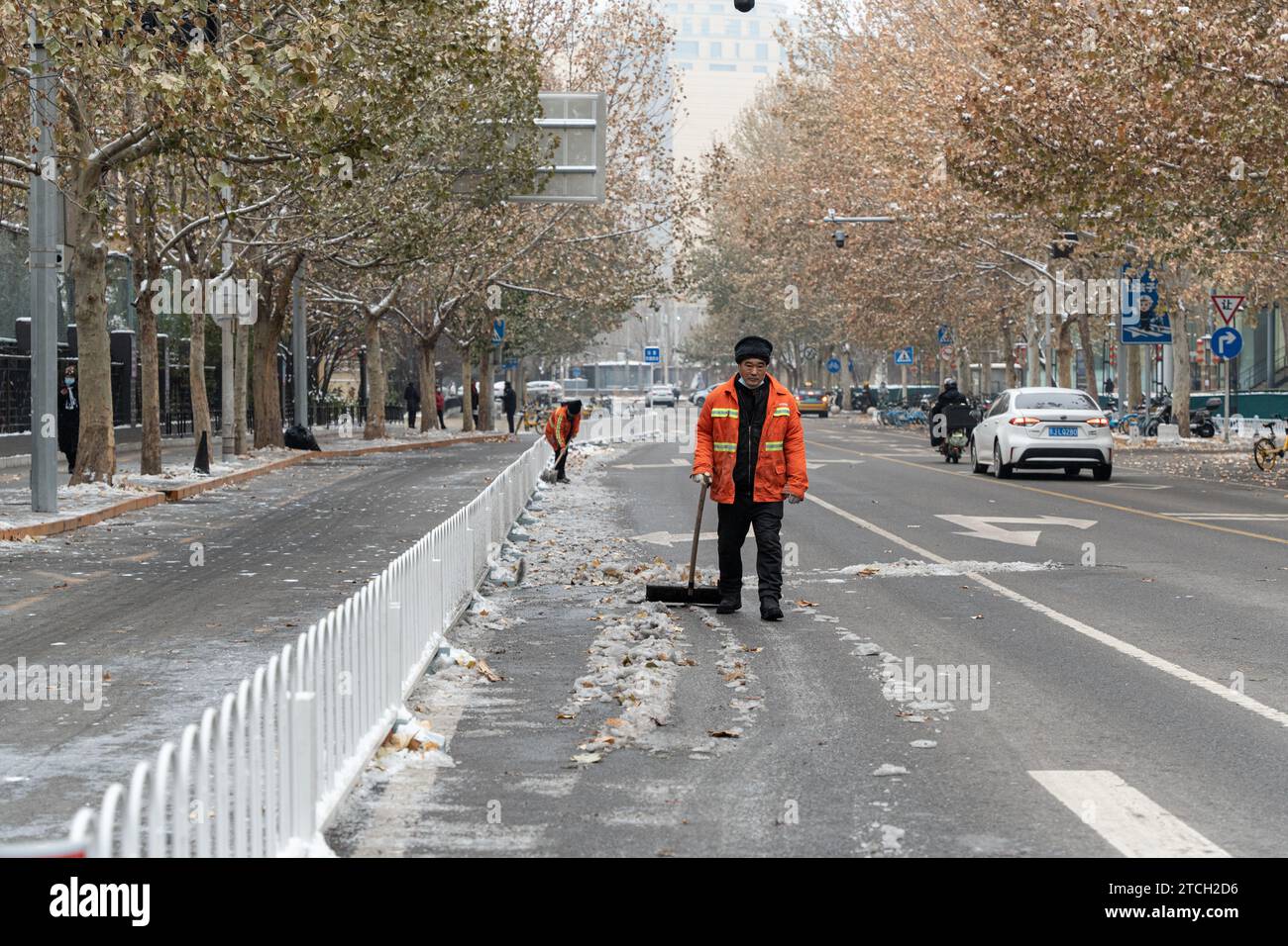 Communal service workers cleaning roads of ice and snow in response to ...