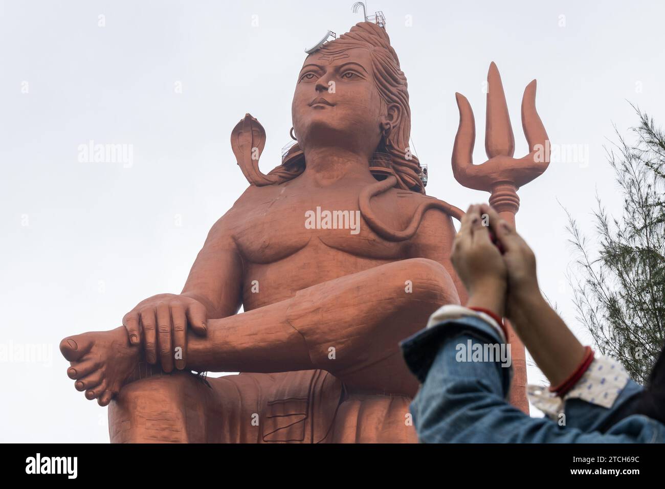 hindu god lord shiva isolated statue with blurred praying hand at ...