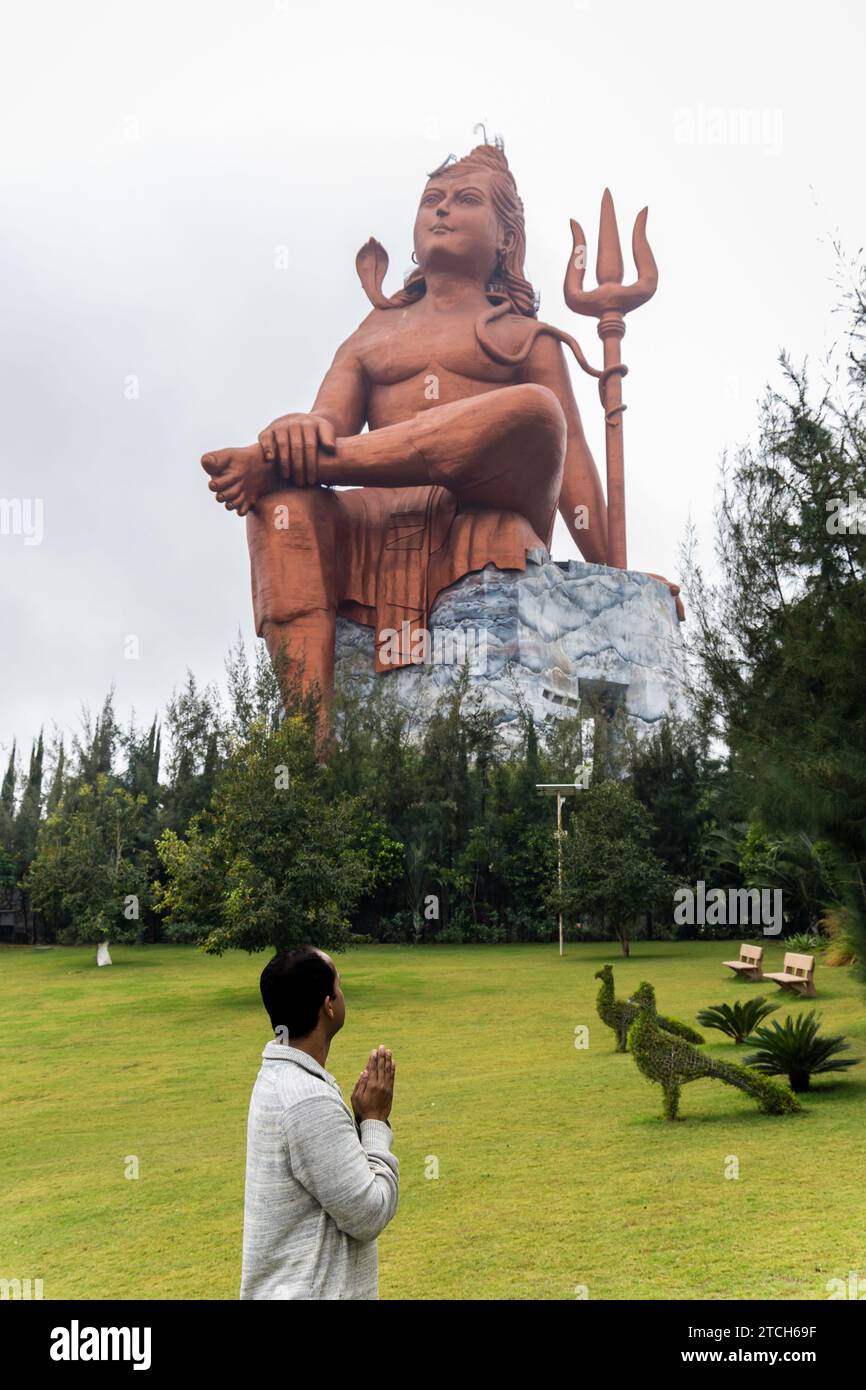 devotee praying to the hindu god lord shiva huge isolated statue at ...