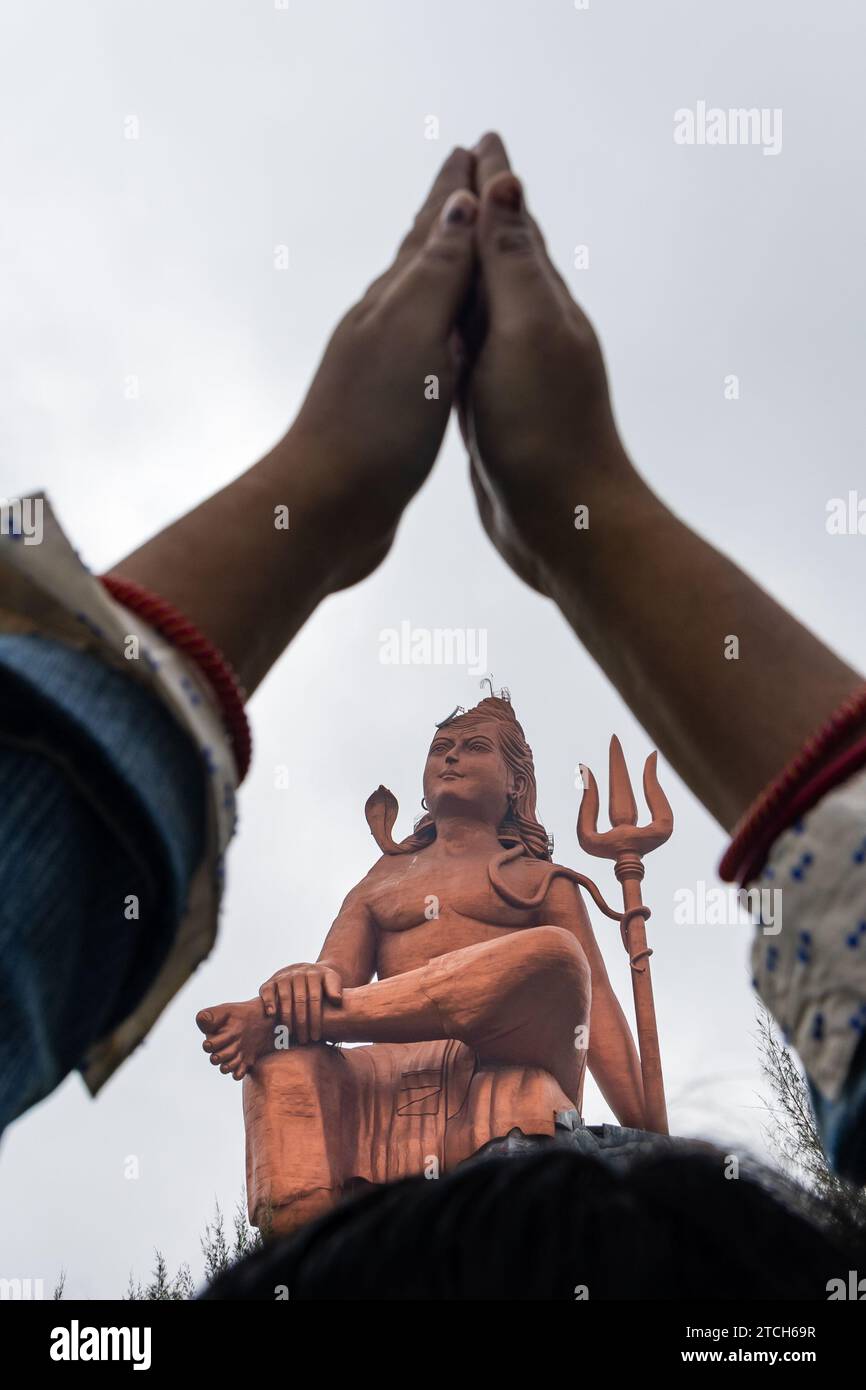 hindu god lord shiva isolated statue through blurred praying hand from ...