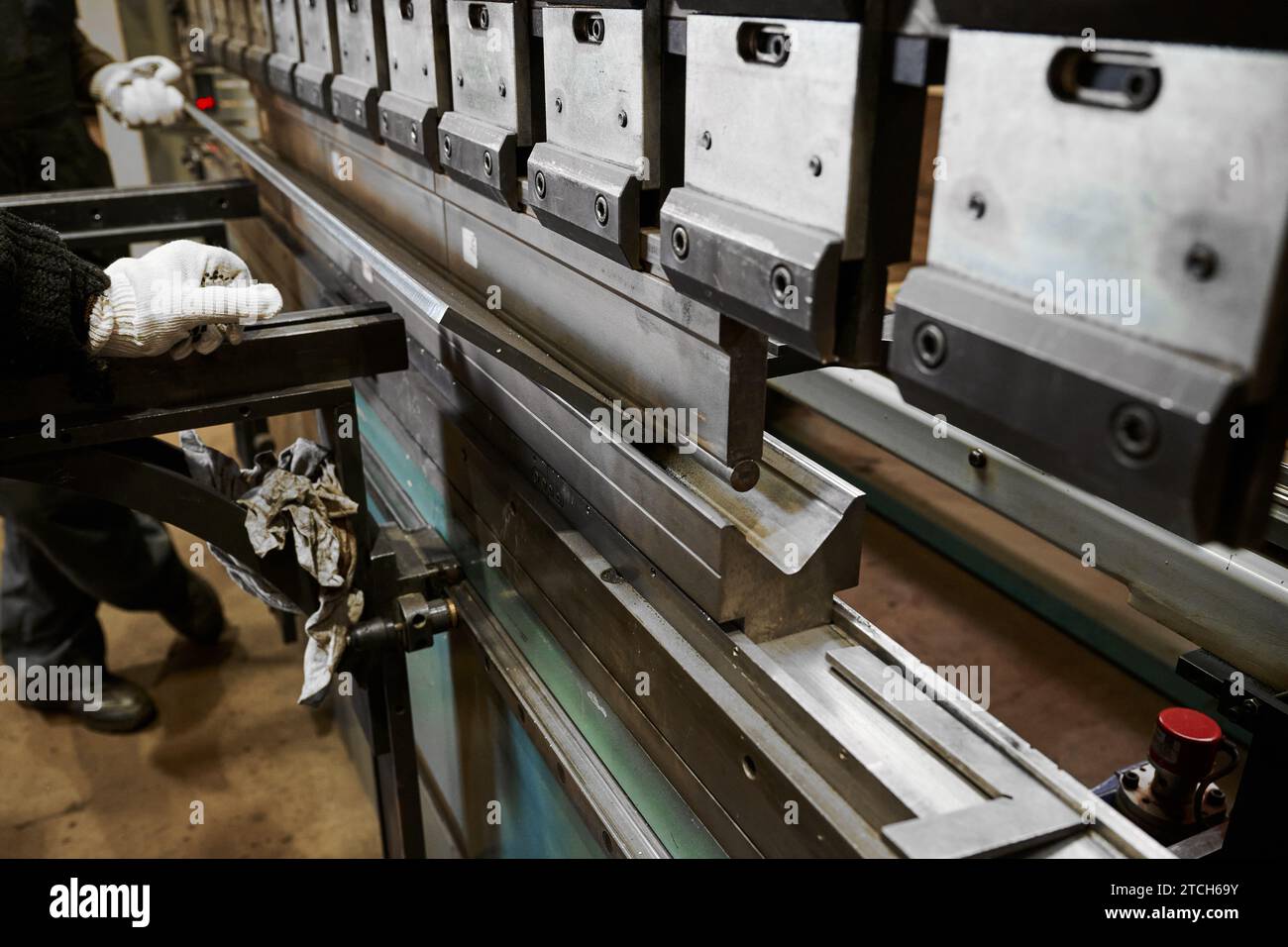 Bending press operates with metal sheet in plant workshop Stock Photo ...