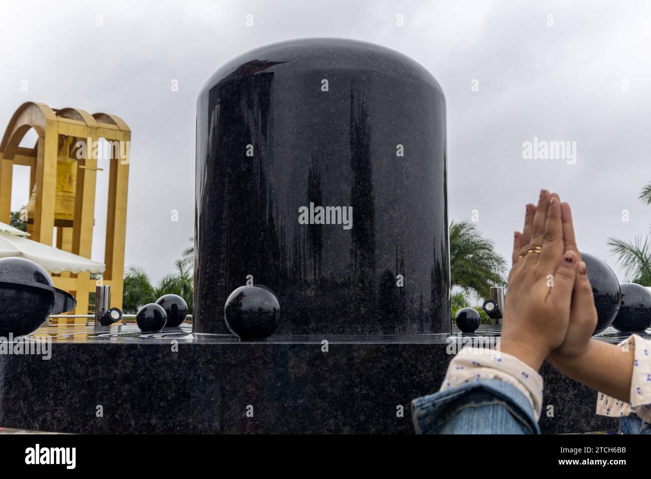 devotee paying salutation to hindu religious symbol Shivalinga at ...