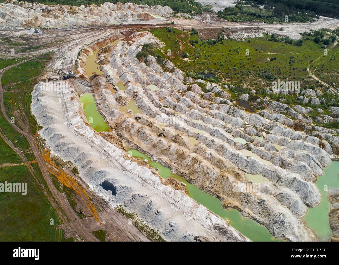 Limestone heaps rows and water in trench at chalkquarry Stock Photo - Alamy