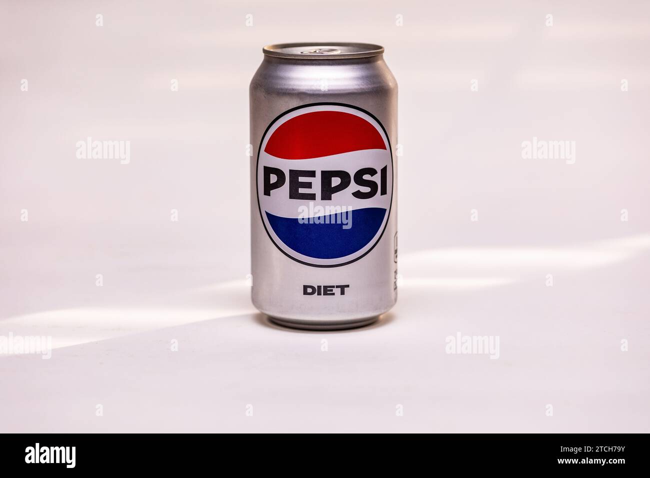 A can of Diet Pepsi on a light colored background with sunlight ...