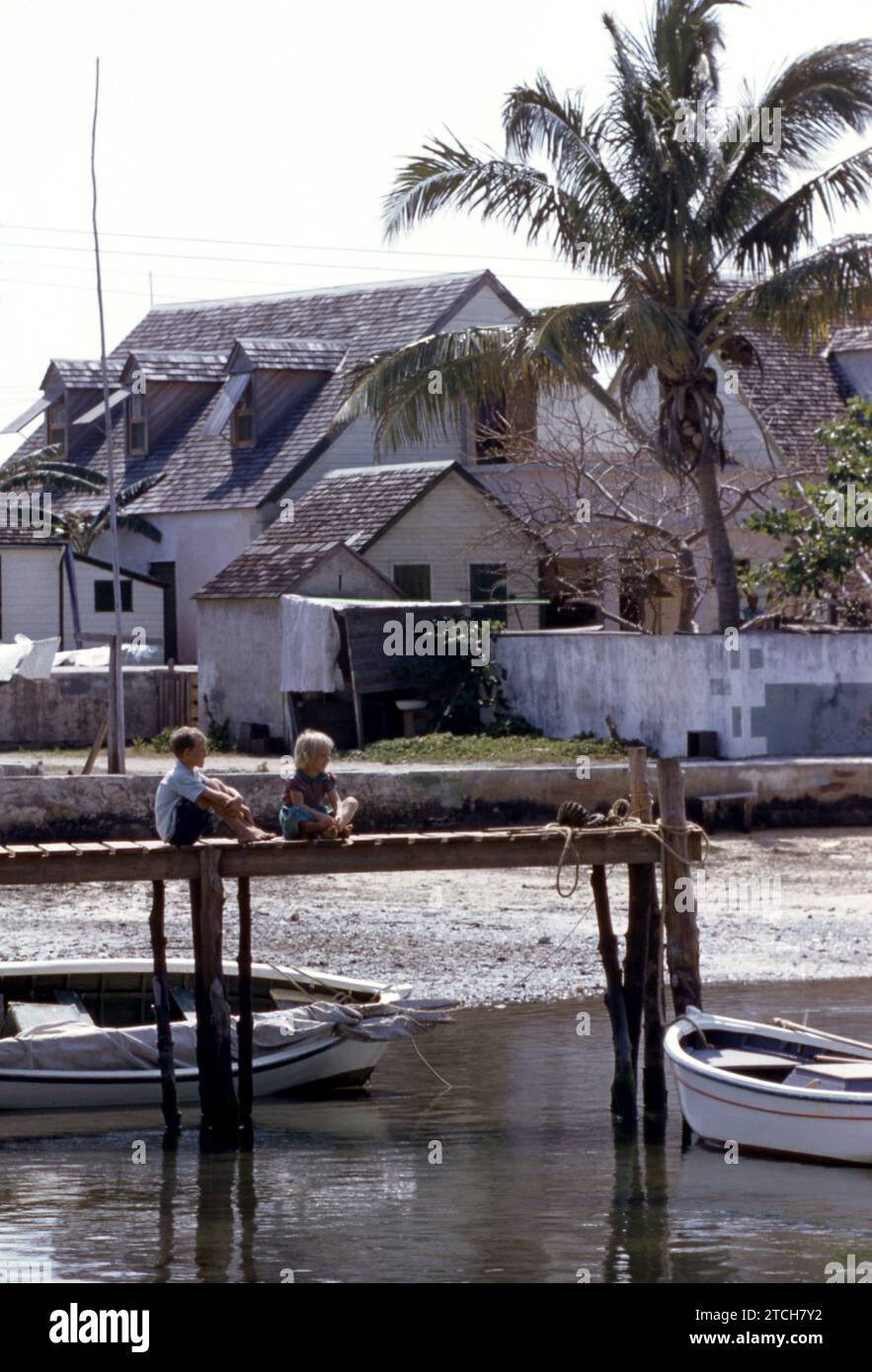 GREEN TURTLE CAY, ABACO, BAHAMAS - APRIL 28: Two young children sit on ...