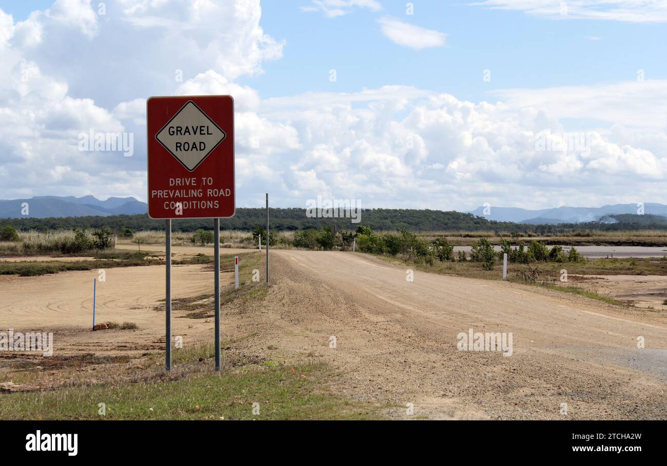 Road sign that reads "Gravel road. Drive to prevailing road conditions ...