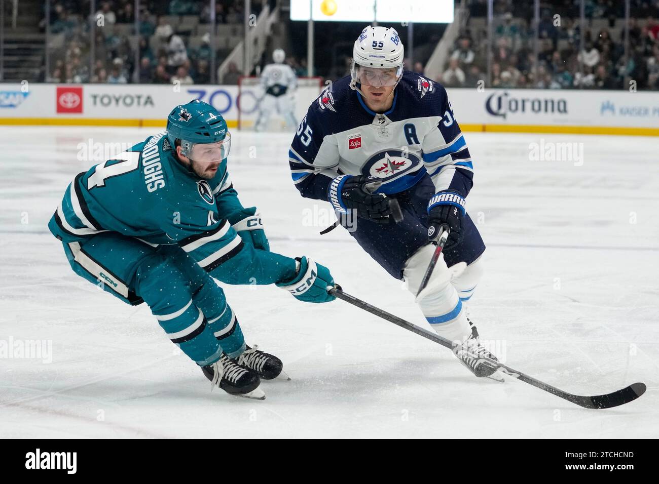 San Jose Sharks defenseman Kyle Burroughs, left, and Winnipeg Jets ...