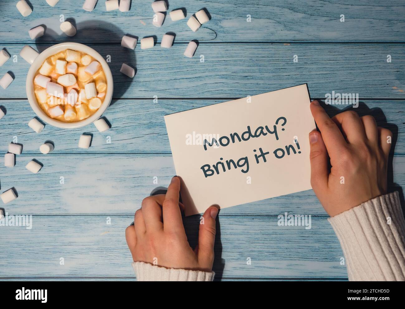 MONDAY BRING IT ON concept text Female hands holding card with white ...