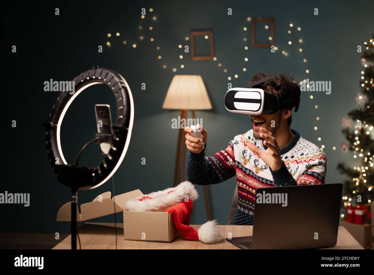 Arab male blogger unboxing parcel with VR Glasses at Christmas Eve at ...