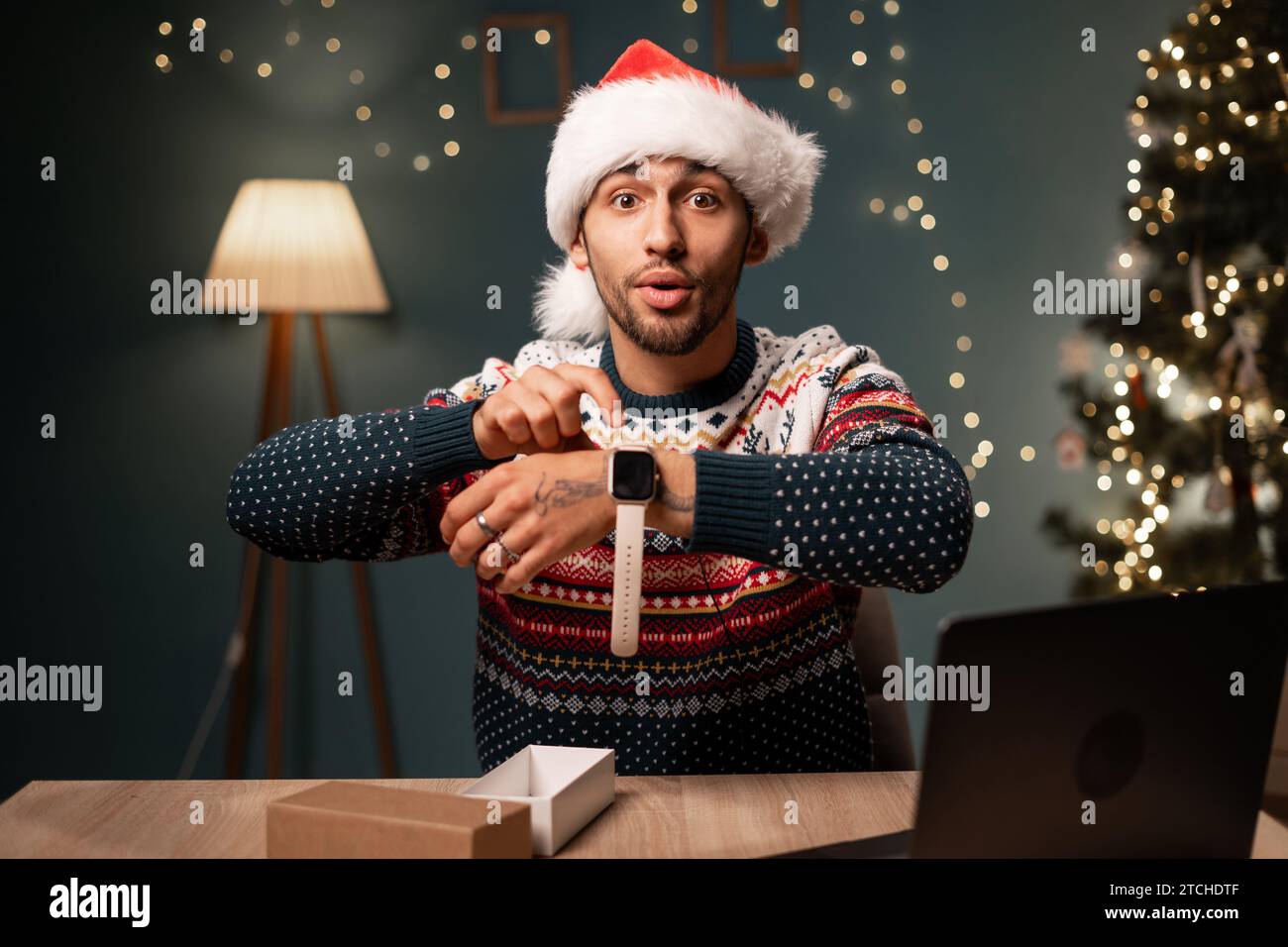 Arabic male influencer wearing Santa hat recording video blog about ...