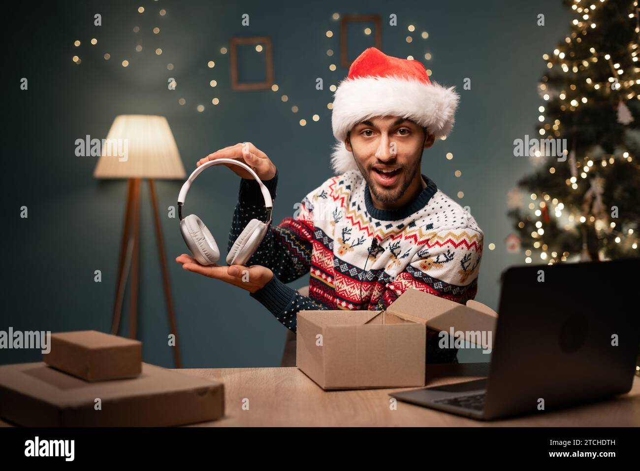 Arab man recording video while unpacking box with new headphones. Male ...
