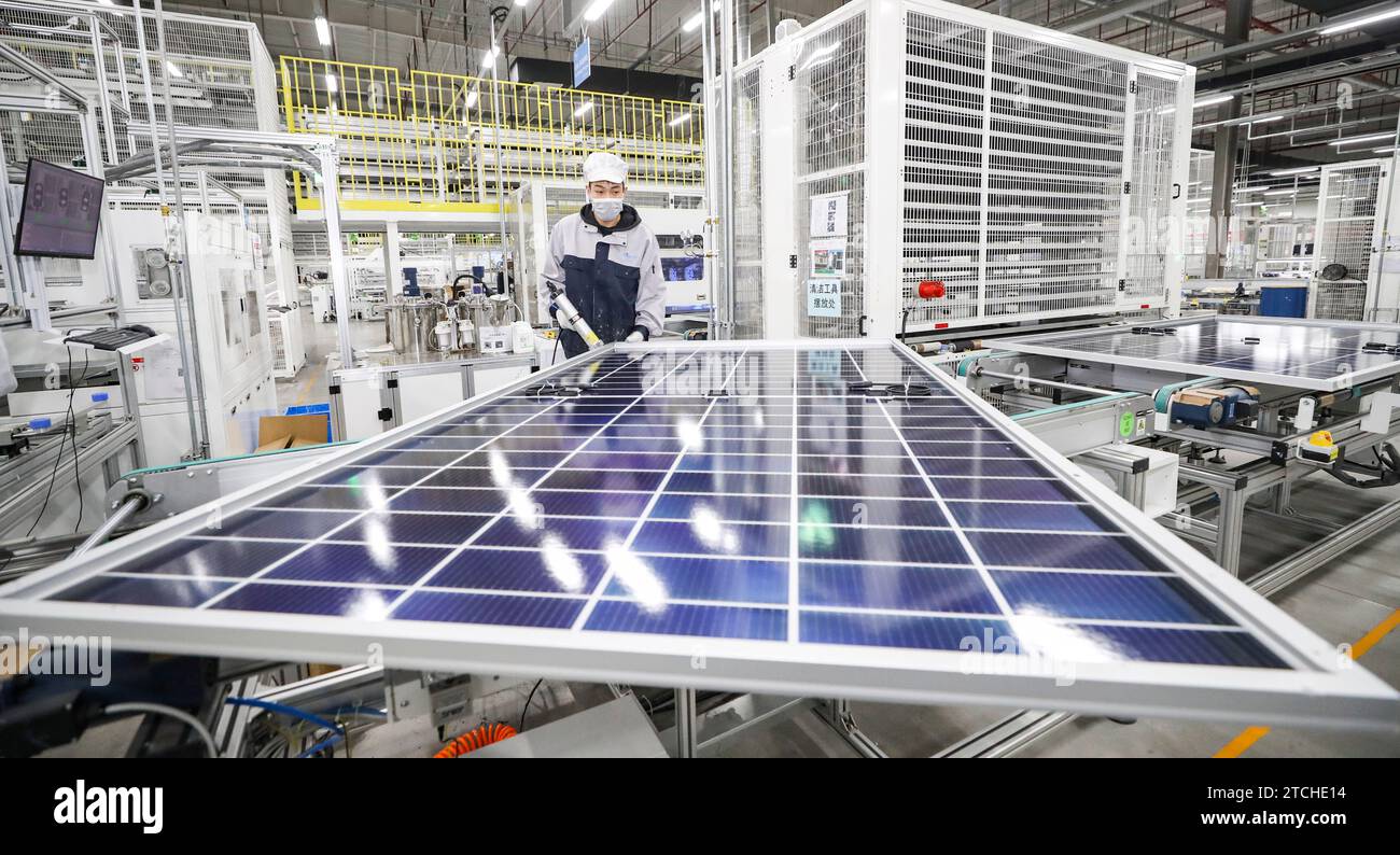 HUAI'AN, CHINA - DECEMBER 13, 2023 - A worker produces photovoltaic ...