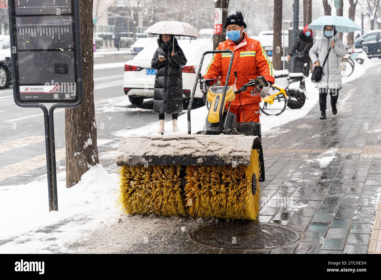 Beijing, China. 13 Dec, 2023. Communal service workers cleaning roads ...