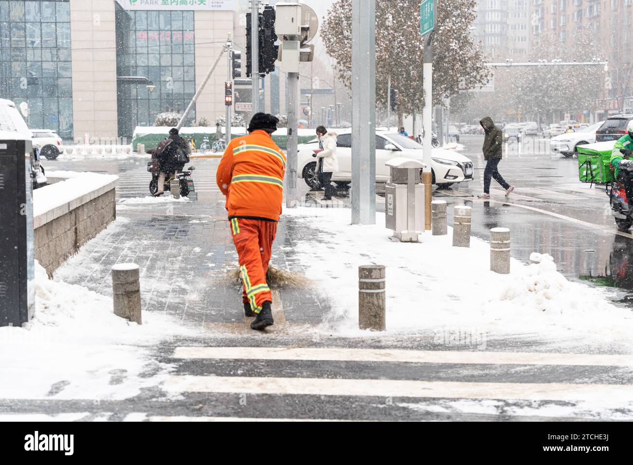 Beijing, China. 13 Dec, 2023. Communal service workers cleaning roads ...