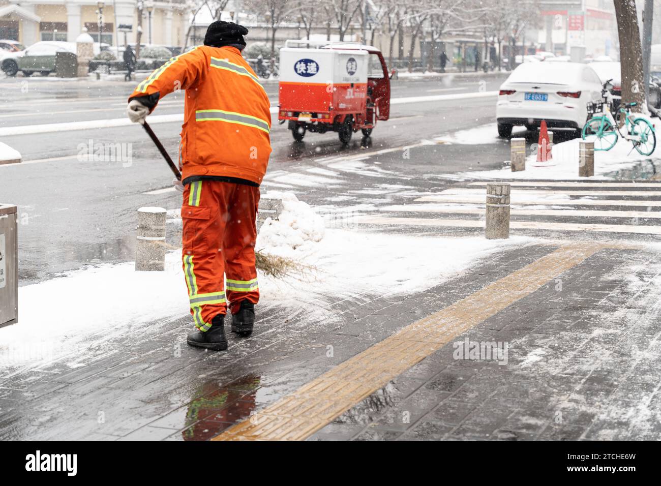 Beijing, China. 13 Dec, 2023. Communal service workers cleaning roads ...