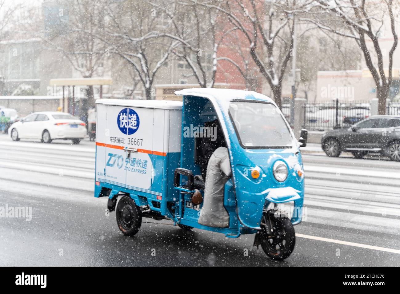 Package delivery truck in a snowstorm, commute to work on slippery icy ...