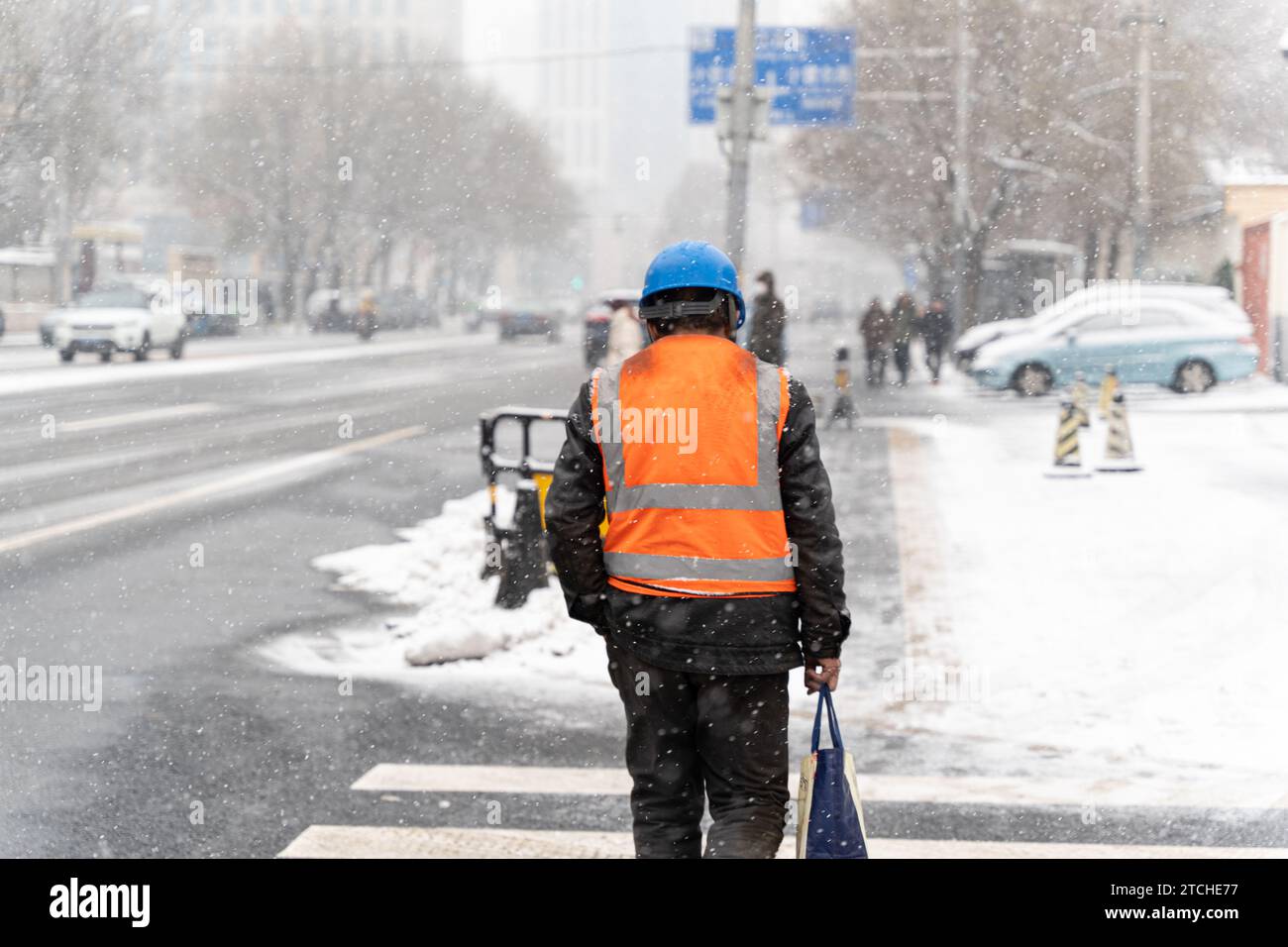 Beijing, China. 13 Dec, 2023. Communal service workers cleaning roads ...