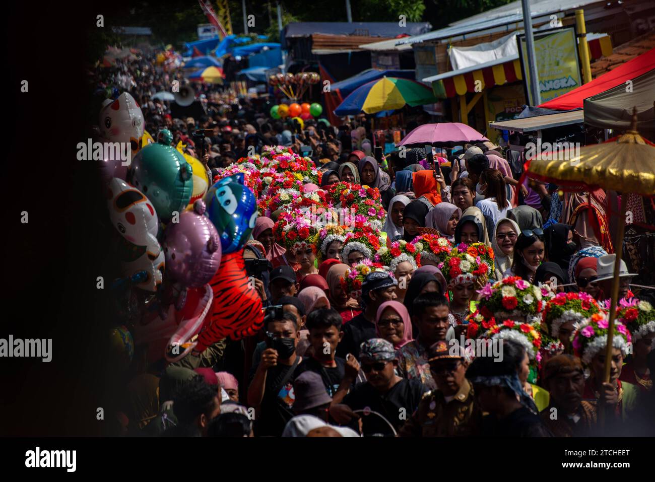 NGAROT FESTIVAL Girls decorated with flowers on their heads participate ...