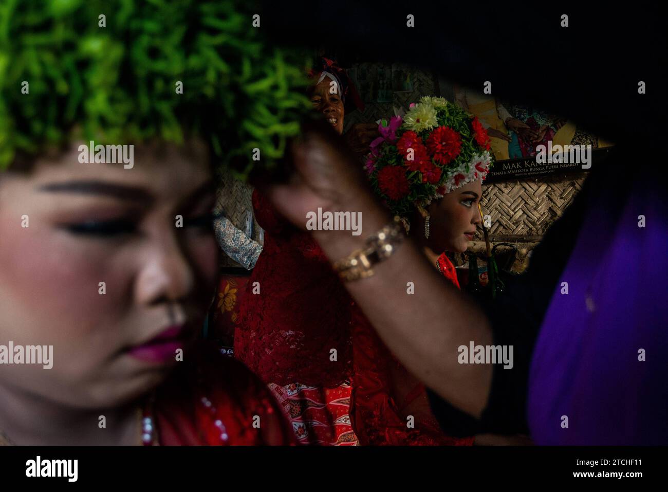 NGAROT FESTIVAL Girls prepares a flower decoration on her head while ...