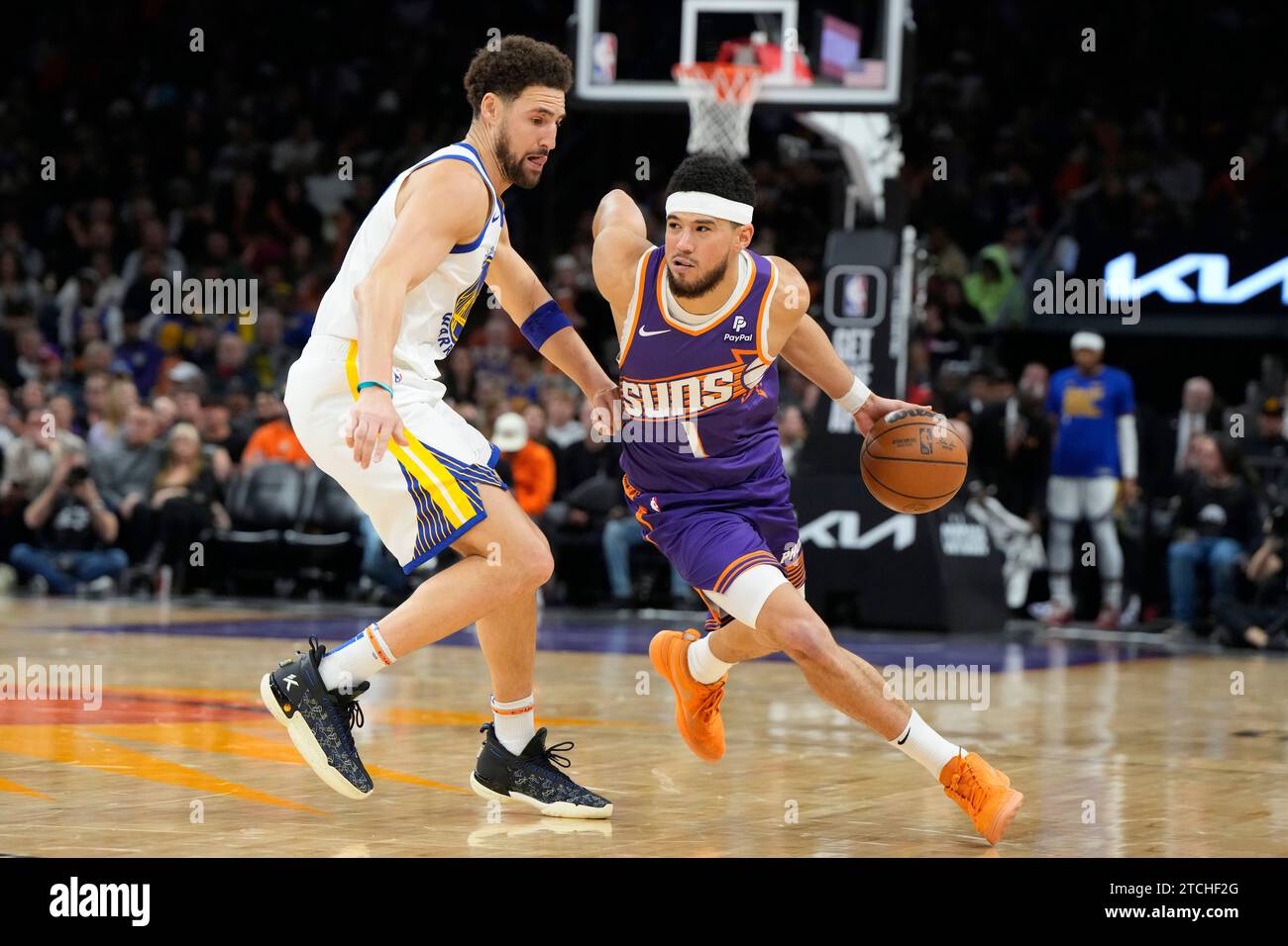 Phoenix Suns guard Devin Booker (1) drives against Golden State Warriors guard Klay Thompson ...