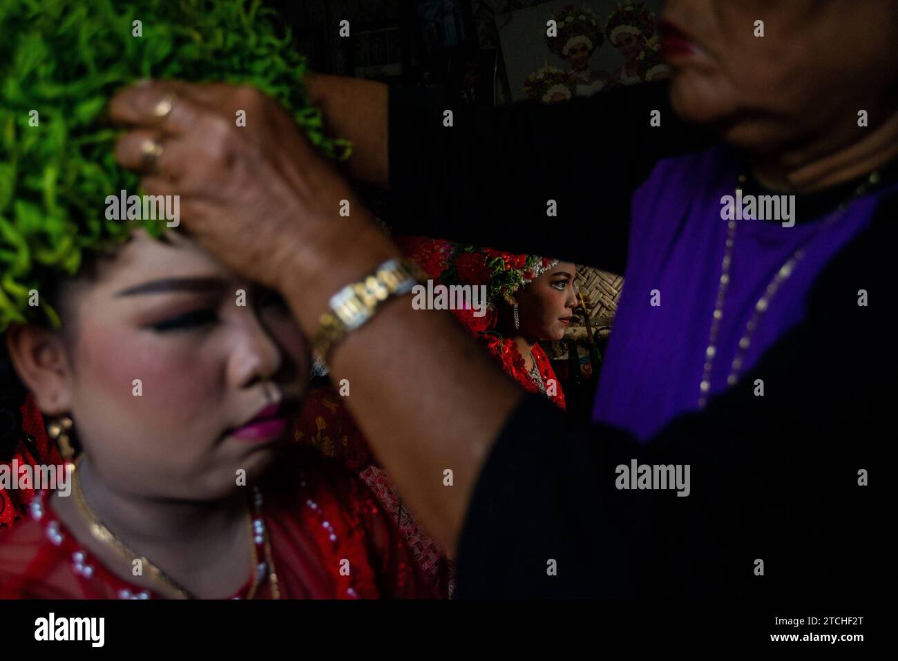 NGAROT FESTIVAL Girls prepares a flower decoration on her head while ...