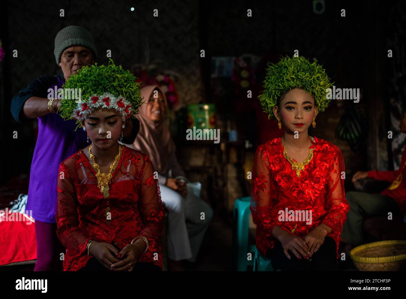 NGAROT FESTIVAL Girls prepares a flower decoration on her head while ...