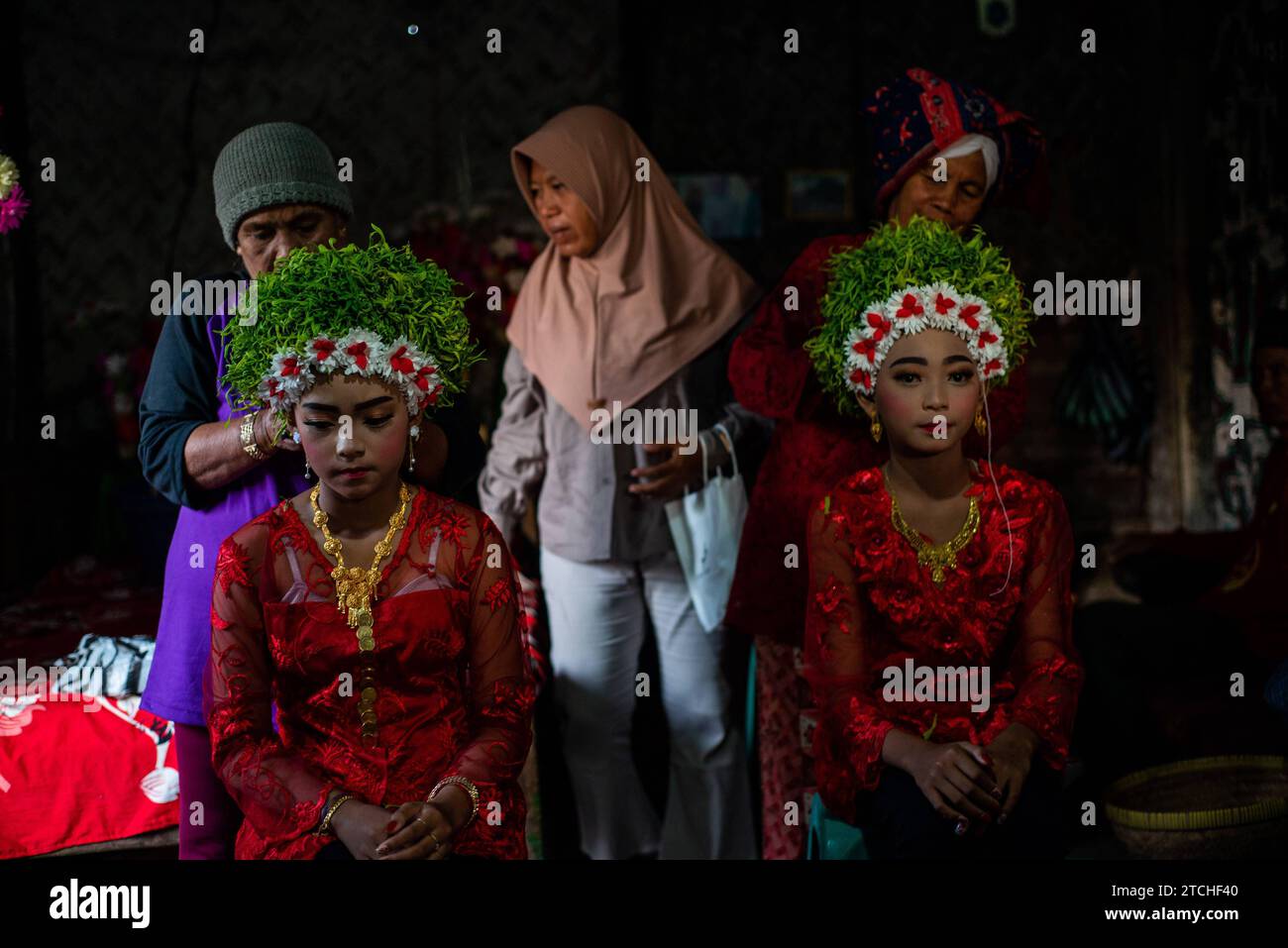 NGAROT FESTIVAL Girls prepares a flower decoration on her head while ...