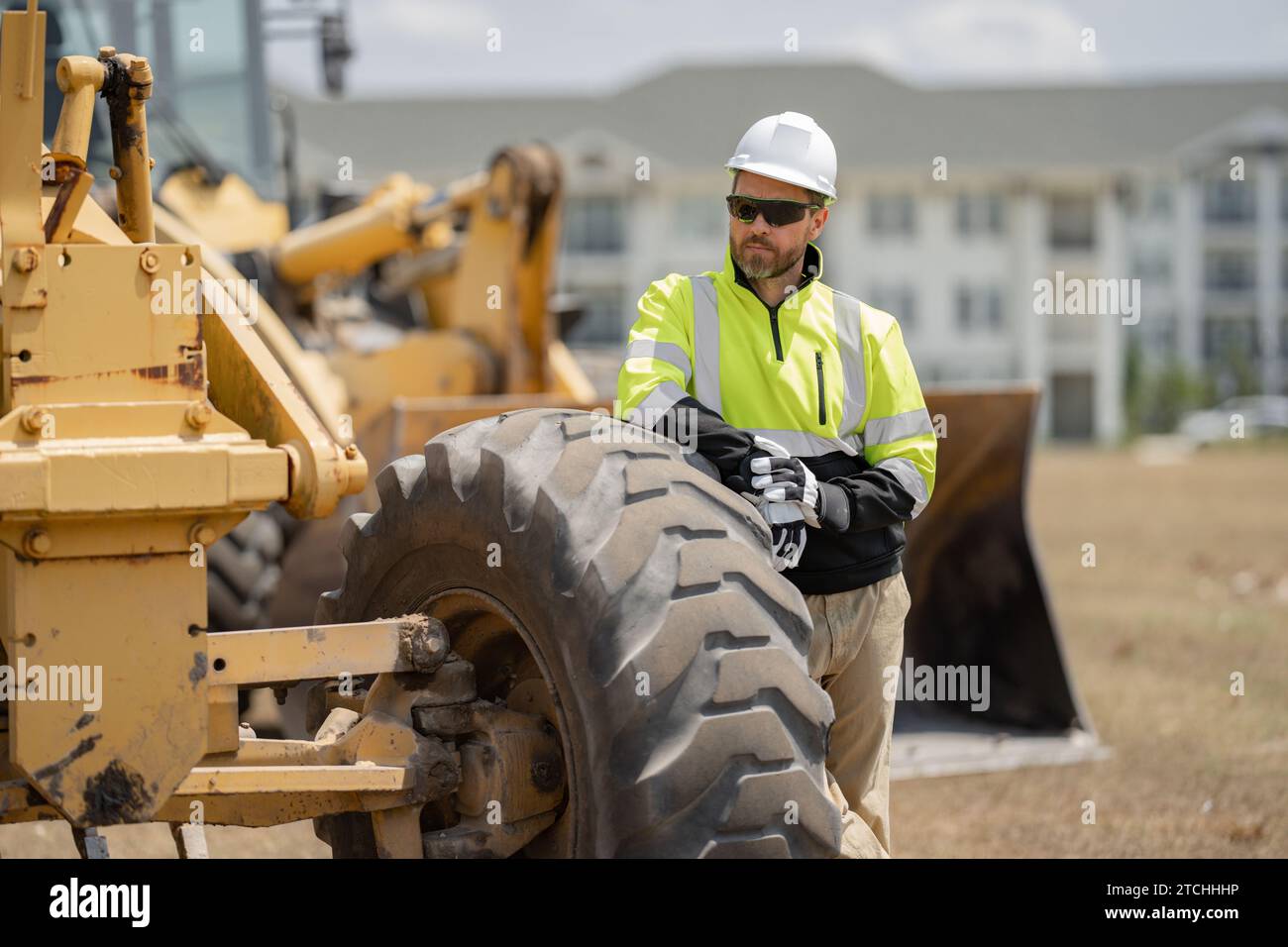 Machinery builder at buildings background. Excavator loader tractor and ...